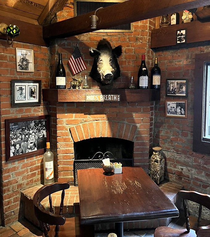 That fireplace isn't just decorative—it's the soul of this dining room, where brick walls and a mounted boar's head tell tales of California's rustic heritage.