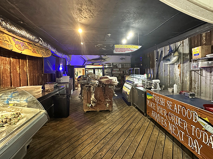 Where the magic happens—wooden floors worn smooth by decades of seafood lovers, with a sign promising "Fresh Seafood" that actually delivers on that promise.