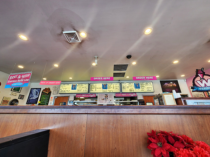 The counter where magic happens—pink neon lighting the way to satisfaction like a runway for incoming flights of deliciousness.