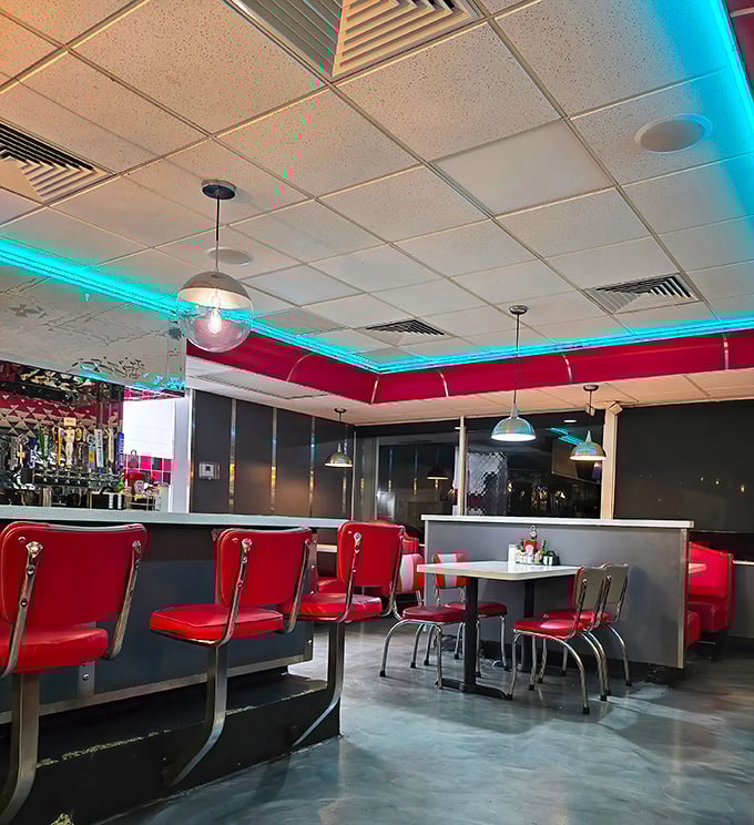 The turquoise neon glow against classic red booths creates that perfect retro vibe—Edward Hopper would've added this scene to his collection.