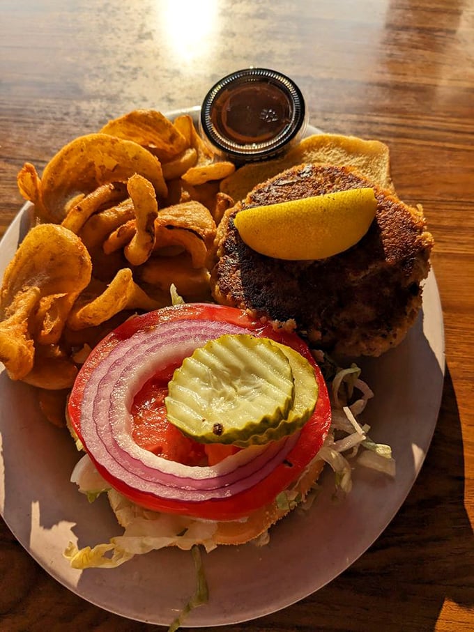 This sandwich doesn't just satisfy hunger—it creates memories. Crispy seafood cake, garden-fresh toppings, and house-made chips that'll haunt your dreams.