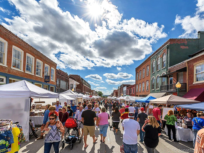 Festival day transforms Main Street into a vibrant community living room. Locals and visitors mingle under blue skies, celebrating small-town America at its finest.