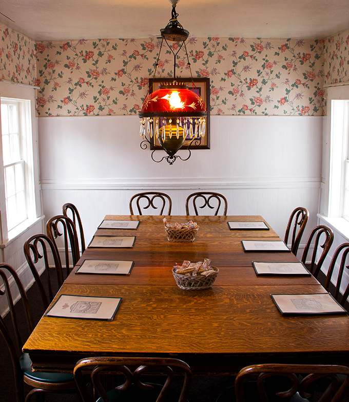 Floral wallpaper, vintage lighting, and a solid oak table—dining rooms like this have witnessed more family celebrations than birthday cakes.