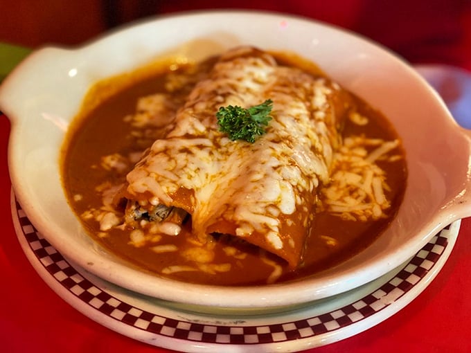 This enchilada doesn't just sit on the plate—it commands attention with its crown of melted cheese and a sauce that's been perfected over generations.