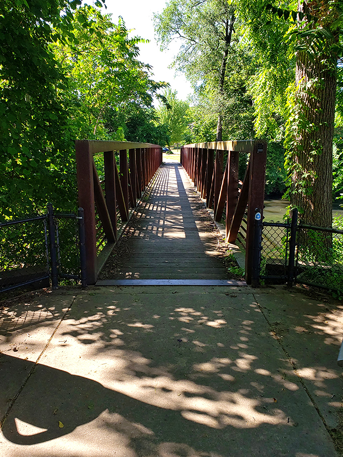The Riverwalk's wooden bridge invites exploration, promising natural beauty just steps away from downtown's historic charms—Michigan's version of having your cake and eating it too.