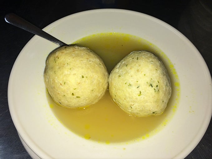 Twin matzah balls floating in golden broth like edible planets in a soul-warming solar system—Jewish penicillin at its finest.