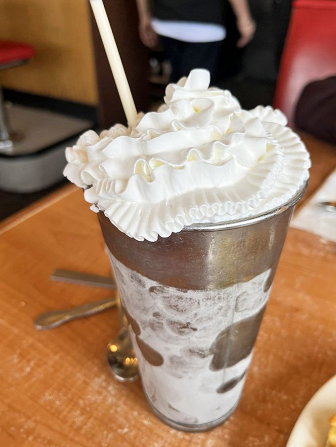 A milkshake towering with whipped cream—dessert masquerading as a beverage, and nobody's complaining.