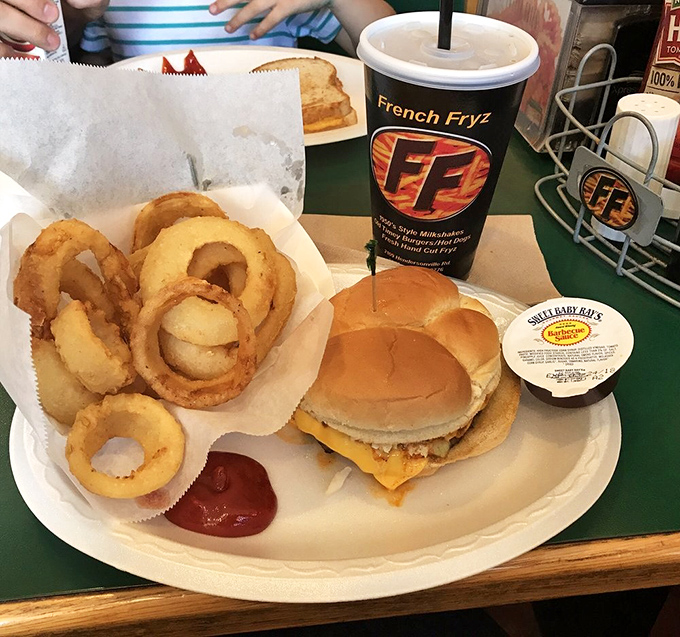 The classic combo that launched a thousand food comas – a cheeseburger and onion rings that would make your cardiologist wince and your taste buds sing.