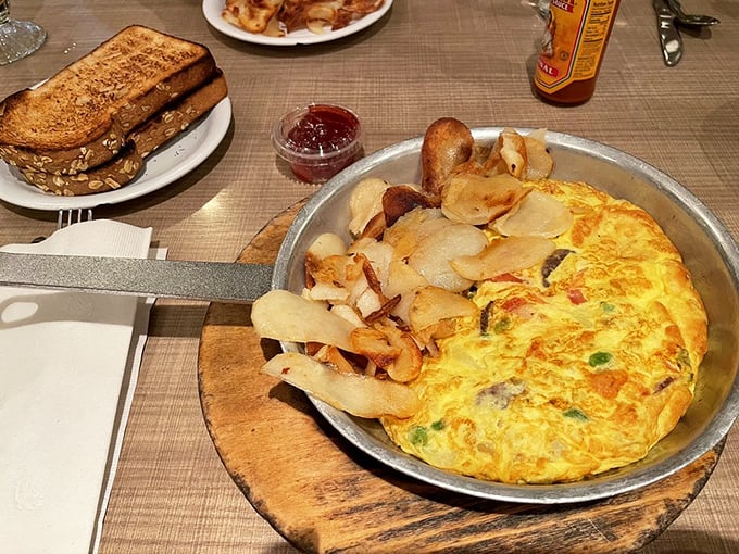 This isn't just an omelet – it's a skillet-born masterpiece that makes ordinary eggs question their life choices. Hash browns that crisp should be illegal.