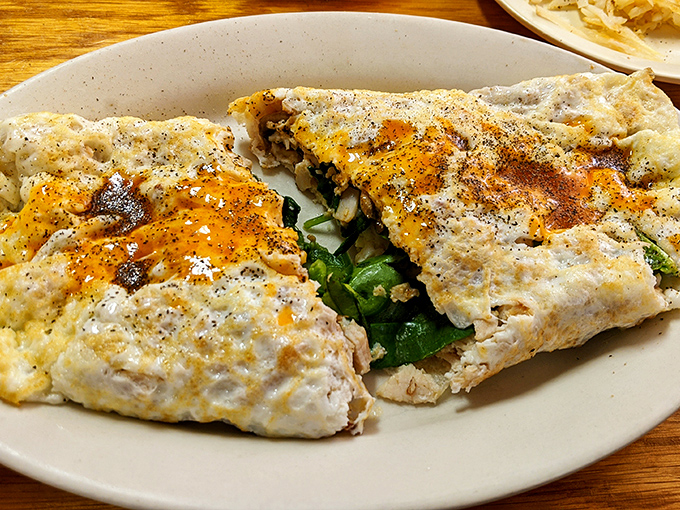 This isn't just an omelet – it's a perfectly executed envelope of egg delivering a love letter to your taste buds.