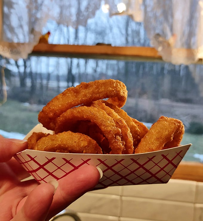 These aren't just onion rings; they're golden halos of happiness. Crispy, substantial, and served in a paper boat—seafaring vessels for flavor voyages.