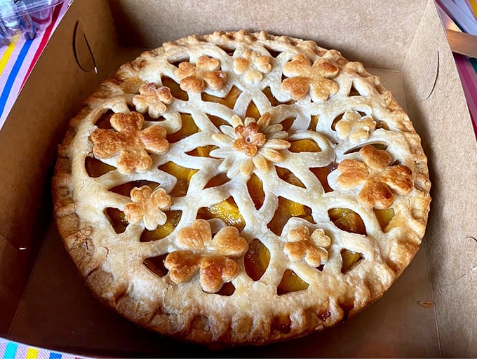 This isn't just a peach pie—it's edible art. The intricate lattice work suggests someone with the patience of a Renaissance sculptor works here.