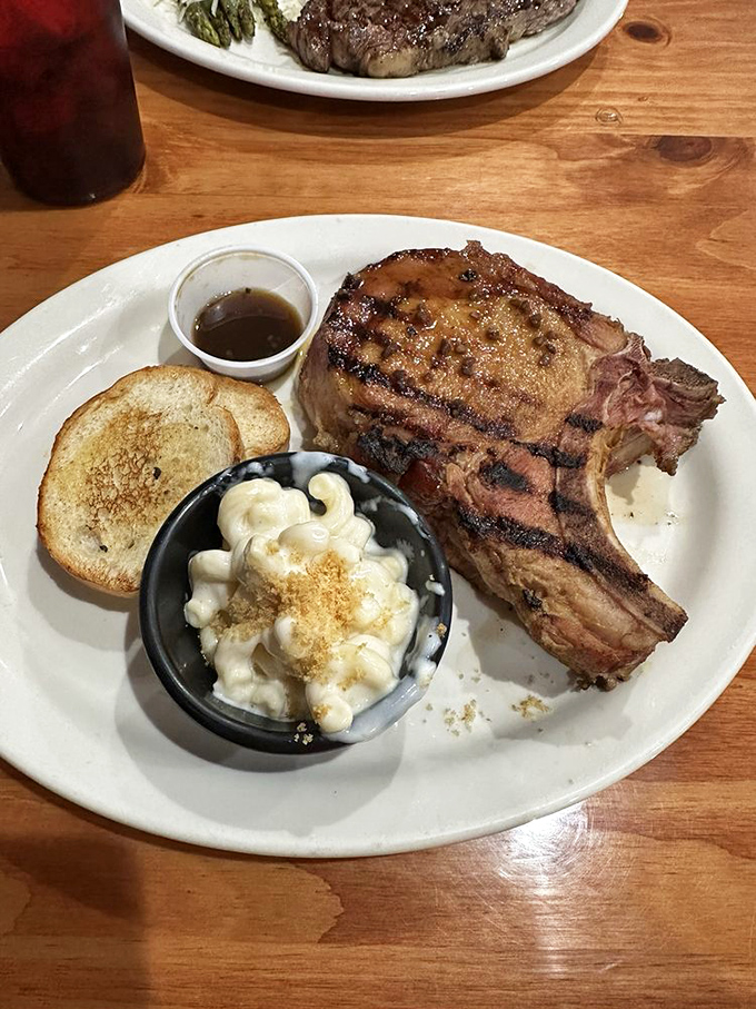 A pork chop so impressive it makes other entrees nervous, served with creamy mac and cheese that's clearly not from a blue box.