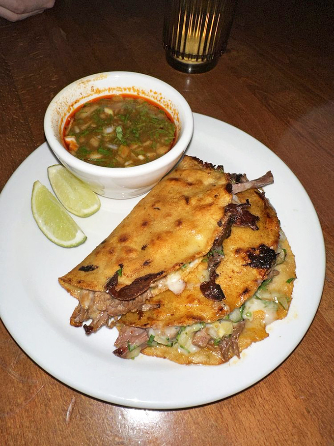 Quesabirria that demands to be dipped in that rich consommé. It's like the taco and French dip had a beautiful baby.