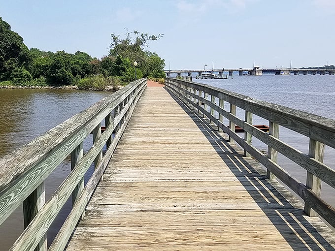 The riverwalk stretches toward the horizon, offering contemplative strolls where the only decision is whether to walk faster or slower.