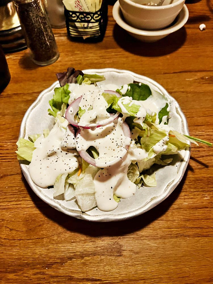 A simple house salad that knows its role – the opening act that refreshes the palate without stealing the show from the steaks.