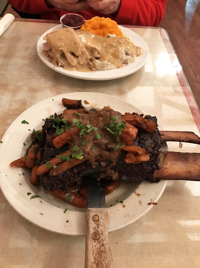 The short rib special arrives like a carnivore's dream—tender meat falling off the bone, surrounded by carrots and draped in savory gravy.