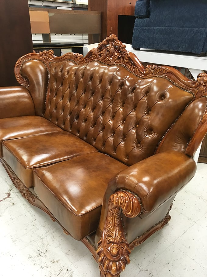 This isn't just a leather sofa—it's a throne for someone's living room, with enough ornate detailing to make Louis XIV nod in approval.