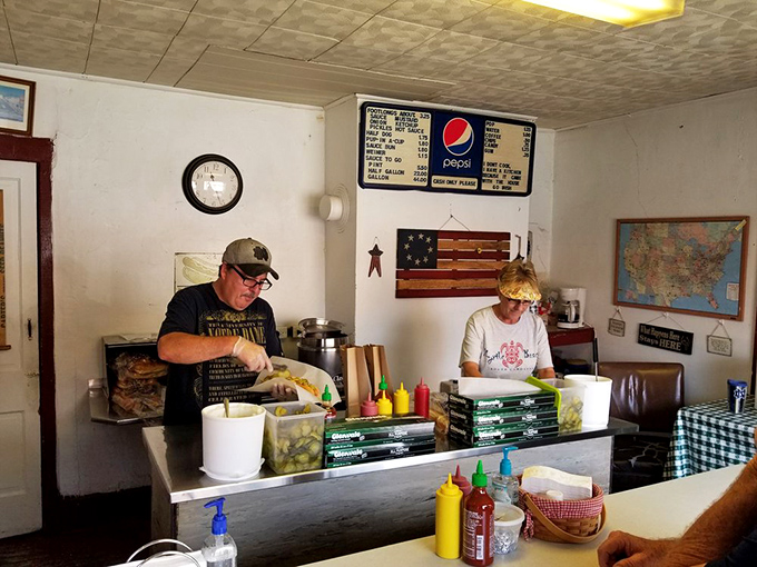 The maestros at work – their hands moving with the practiced precision that comes only from preparing thousands of hot dogs to perfection.