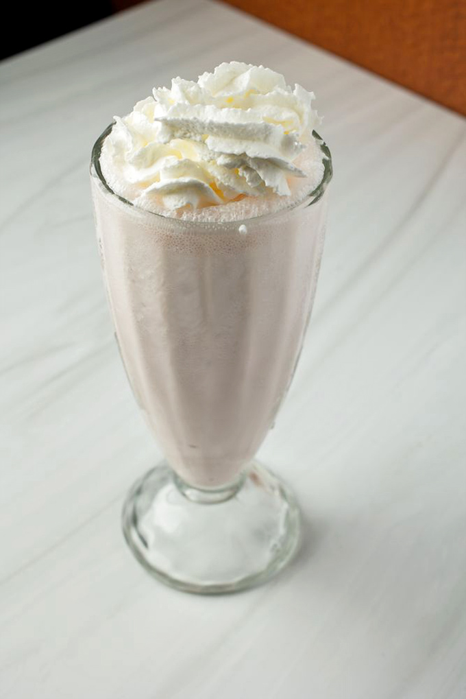 This isn't just a milkshake—it's dessert with a straw. Creamy, dreamy, and topped with enough whipped cream to make your inner child giggle.