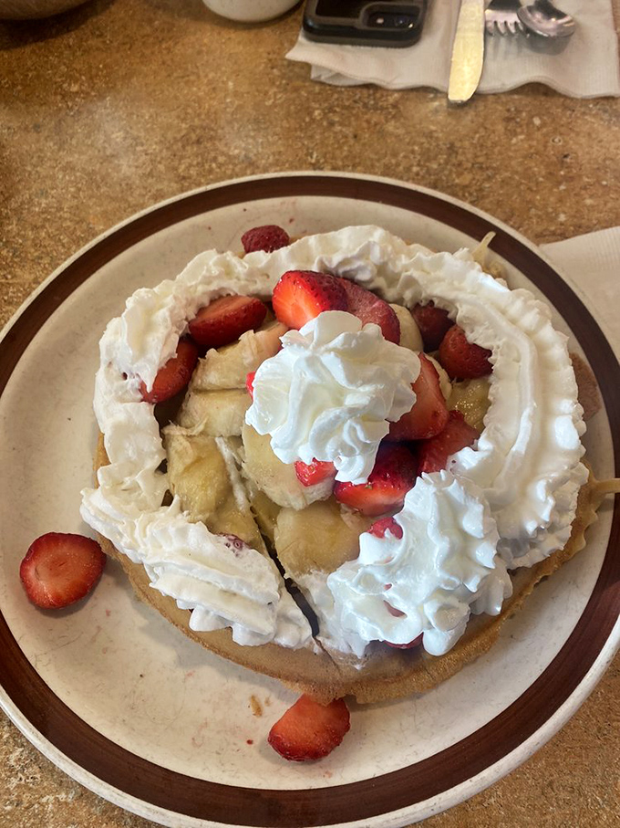 A waffle that's dressed for success with fresh strawberries, bananas and enough whipped cream to make you question your life choices – in the best possible way.