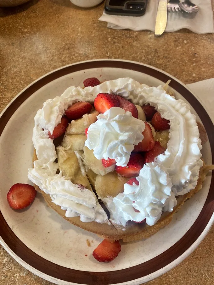 A waffle that's dressed for success with fresh strawberries, bananas and enough whipped cream to make you question your life choices – in the best possible way.