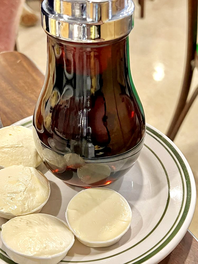 That classic glass syrup dispenser—the unsung hero of breakfast, ready to transform pancakes from good to transcendent.