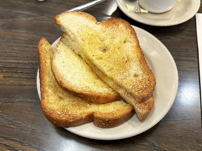 Toast done right – golden-brown, butter-kissed slices that prove even the simplest items deserve proper attention and respect.
