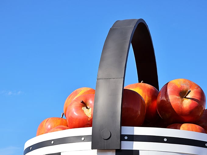 Those aren't small apples—that's a massive handle! The basket's crown jewel arches dramatically against the sky like a wooden rainbow.