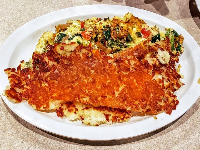 This veggie omelet with crispy hash browns is breakfast architecture at its finest—a savory skyscraper of morning deliciousness.