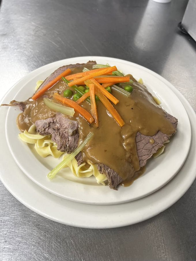 Yankee pot roast that would make your grandmother nod in approval—fork-tender beef surrendering to its savory gravy over a bed of egg noodles.