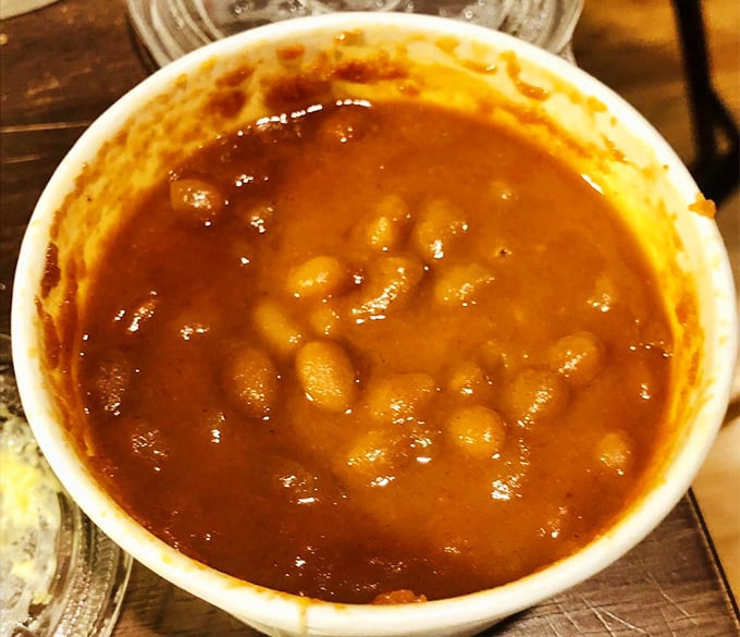 These rum-kissed baked beans have clearly been simmering since breakfast, plotting how to steal the spotlight from the main attraction.