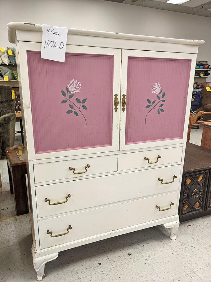 This white and pink cabinet with rose details isn't just furniture – it's a time machine to someone's 1980s bedroom, "HOLD" tag and all.