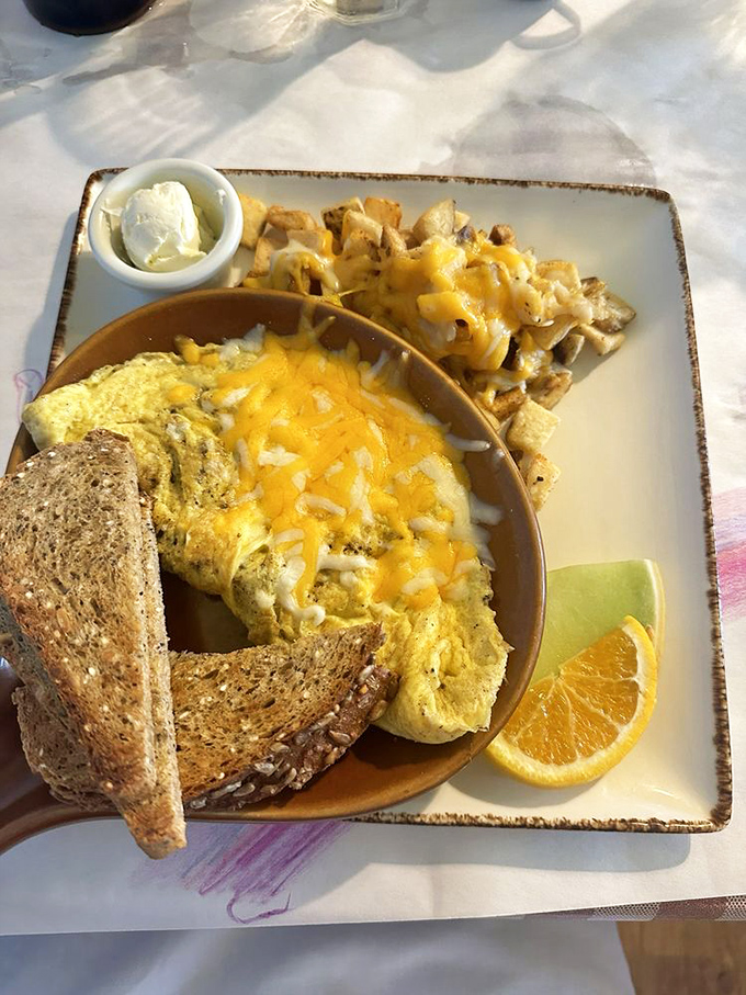 An omelet that's seen the cheese drawer and said, "Yes to all of the above," served with perfectly golden breakfast potatoes.
