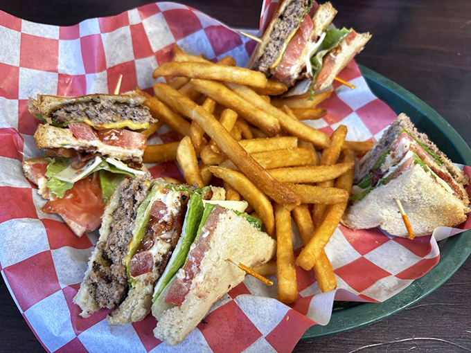 The club sandwich, quartered for maximum enjoyment, stands tall among a sea of golden fries – a lunch landmark worth the journey.