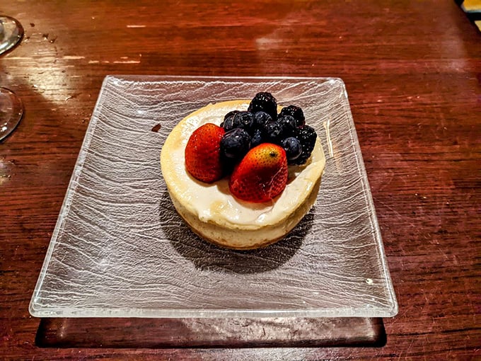 Fresh berries stand guard atop a cloud of cheesecake like jewels in a crown – nature's candy meets creamy indulgence in perfect harmony.
