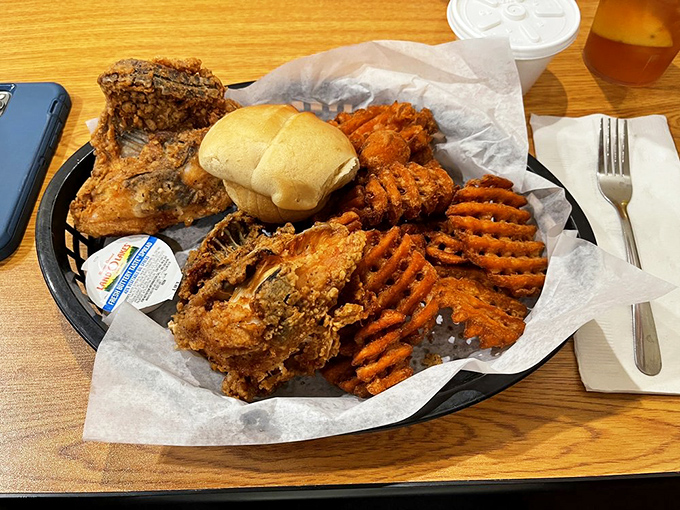 The holy trinity of comfort: crispy chicken, sweet potato waffle fries, and a soft roll—no fancy garnishes needed when the basics are this good.