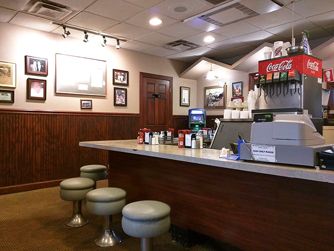 The counter where magic happens—coffee mugs stacked like trophies and the quiet efficiency of a diner that knows exactly what it's doing.