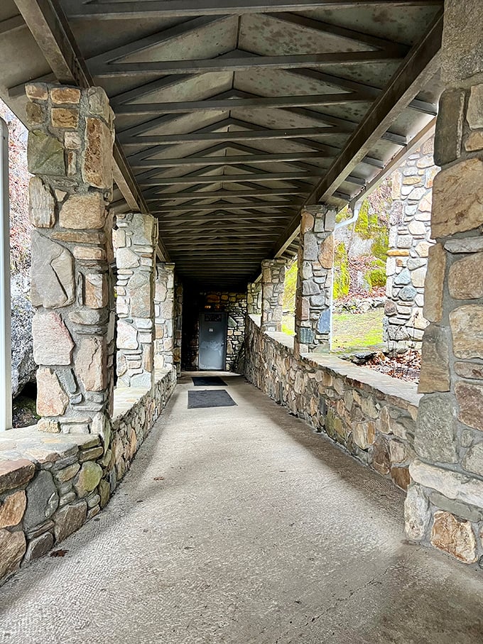This covered stone walkway serves as the decompression chamber between everyday life and the ancient world waiting below.