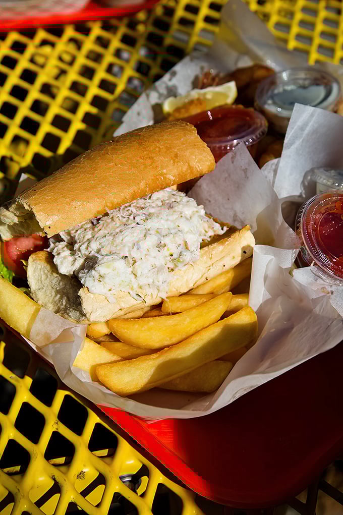 A crab sandwich served in a yellow basket – when seafood is this fresh, paper plates become fine china.