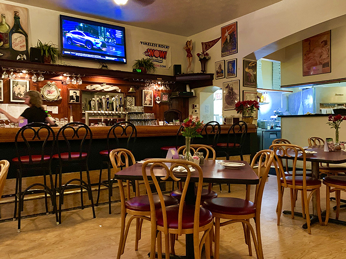 The dining area balances casual comfort with old-school charm – those wooden chairs have supported generations of happy eaters.