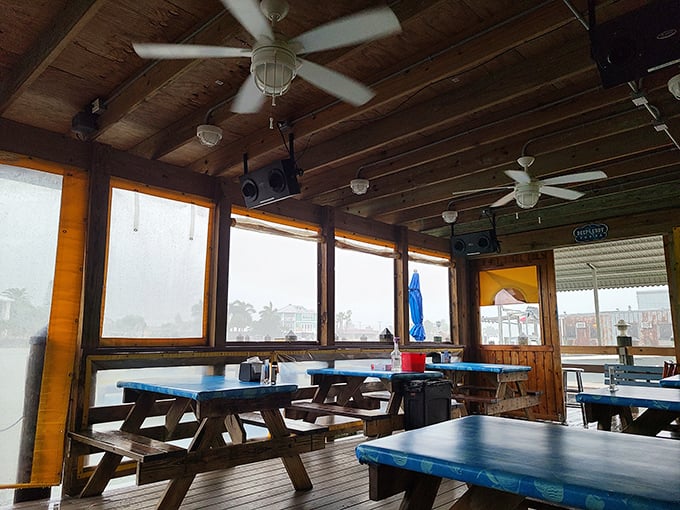 Windows that frame the Florida sunshine, ceiling fans spinning lazily overhead—this dining area knows exactly what coastal comfort should feel like.