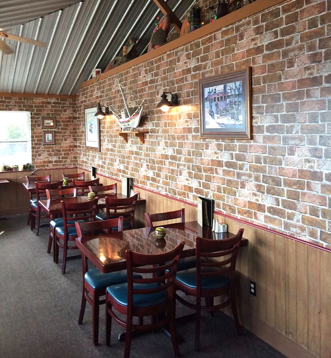 Dining room where brick walls meet wooden warmth. The nautical touches aren't from a designer's catalog—they're collected memories of life on the water.