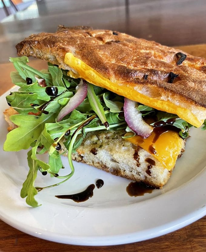 Not just a sandwich but a carefully constructed flavor landscape—crispy bread, peppery arugula, and that balsamic drizzle playing the perfect supporting role.