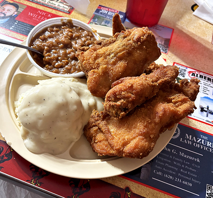 The gravy-topped mashed potatoes and savory baked beans provide the perfect supporting cast for the star of the show – that glorious fried chicken.