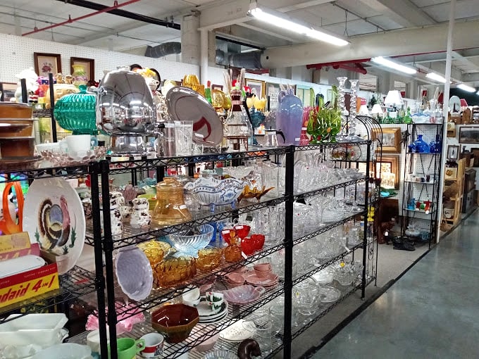 Crystal, colored glass, and delicate dishes catch the light and imagination – each piece silently whispering stories of dinner parties long past.