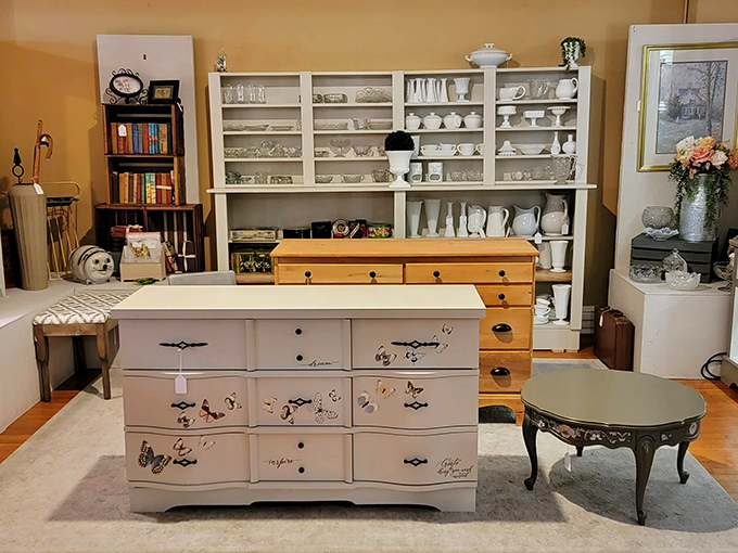 White-painted furniture with delicate butterfly details—proof that sometimes the most charming pieces are the ones that whisper rather than shout.