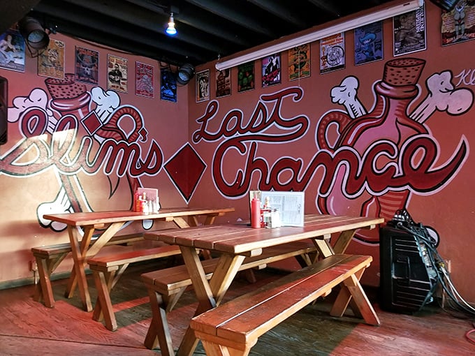 The wall mural says it all—this is your "Last Chance" for authentic chili before hitting the road. Picnic tables invite lingering conversations.