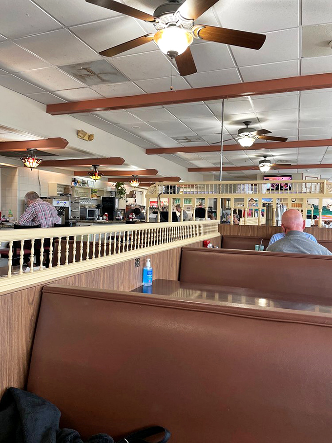 Tiffany-style pendant lights illuminate booths where breakfast dreams come true every single morning without fail.