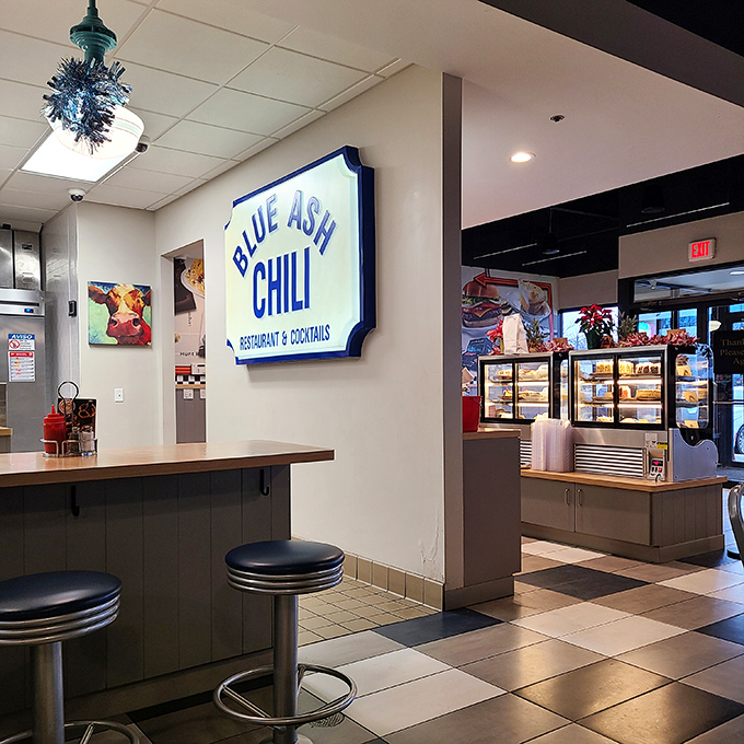The interior balances retro charm with modern comfort. That Blue Ash Chili sign isn't just decoration—it's a beacon of hope for the hungry.